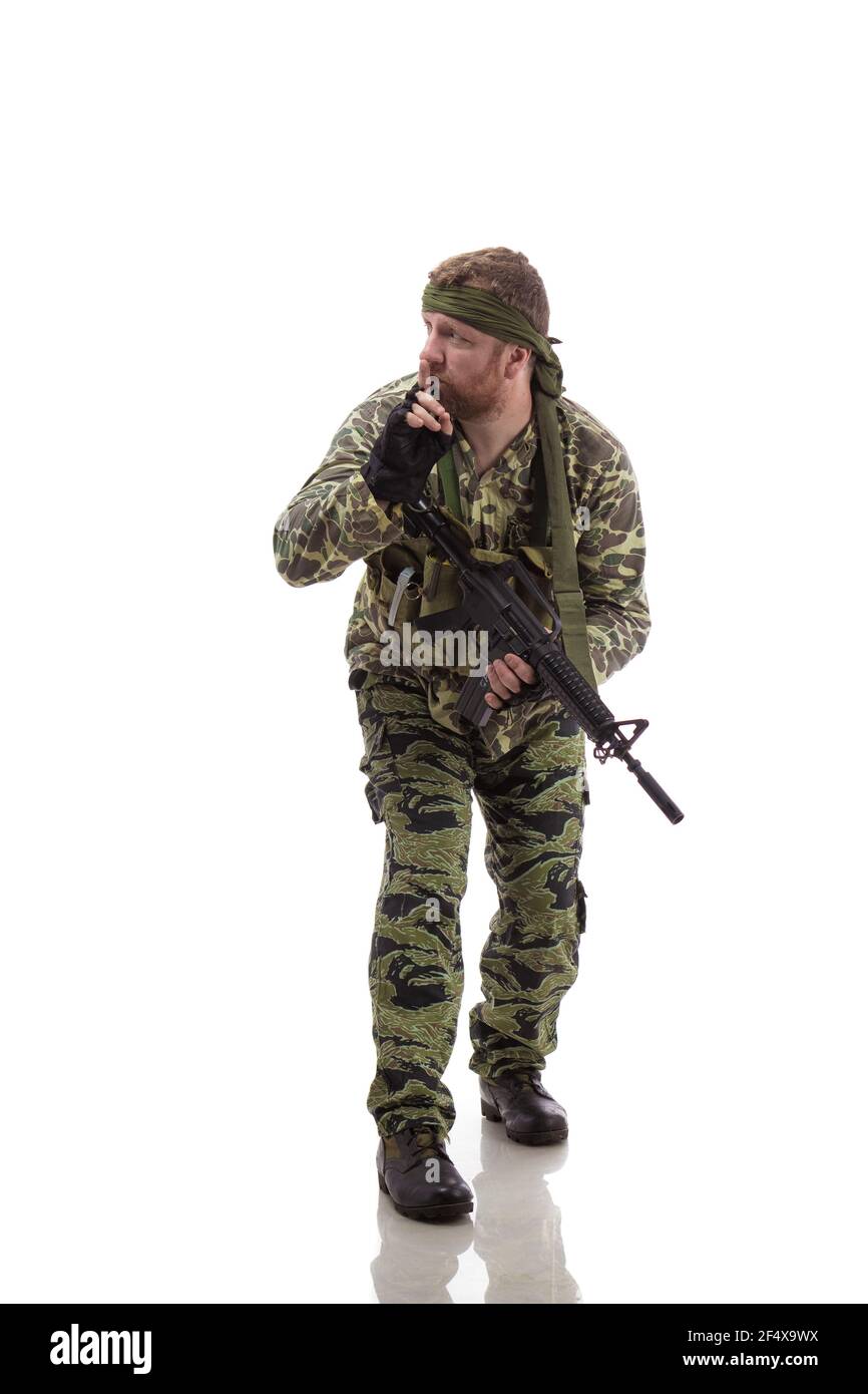 Man actor in the form of an American fur seal posing with a machine gun ...