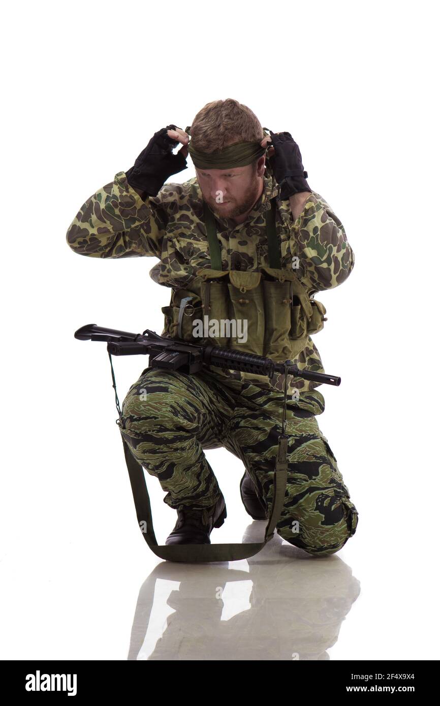 Man actor in the form of an American fur seal posing with a machine gun ...