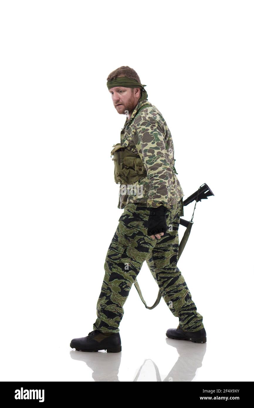 Man actor in the form of an American fur seal posing with a machine gun ...