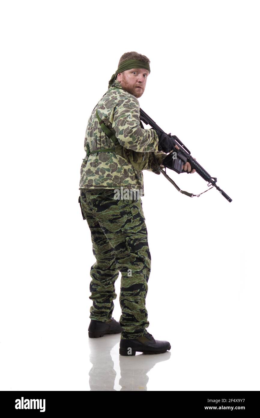 Man actor in the form of an American fur seal posing with a machine gun ...
