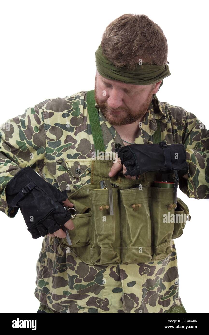 Man actor in the form of an American fur seal posing with a machine gun ...