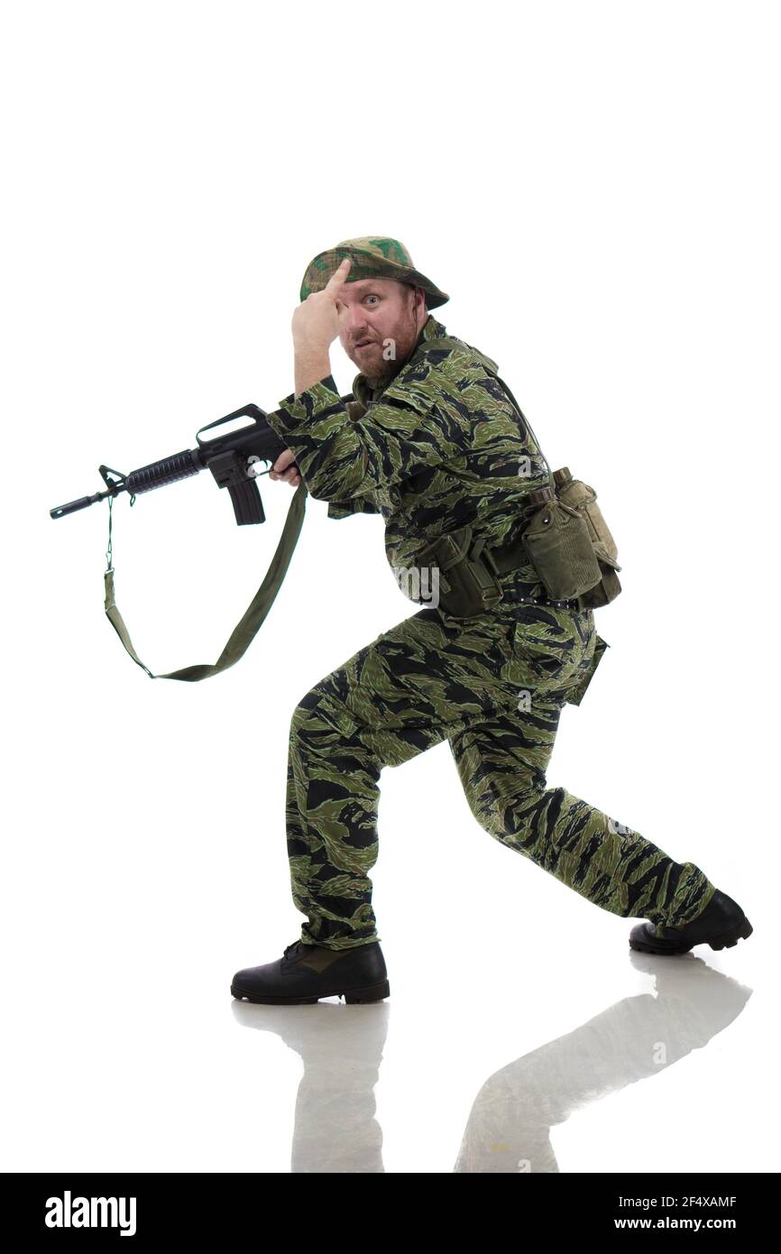 Man actor in the form of an American fur seal posing with a machine gun ...