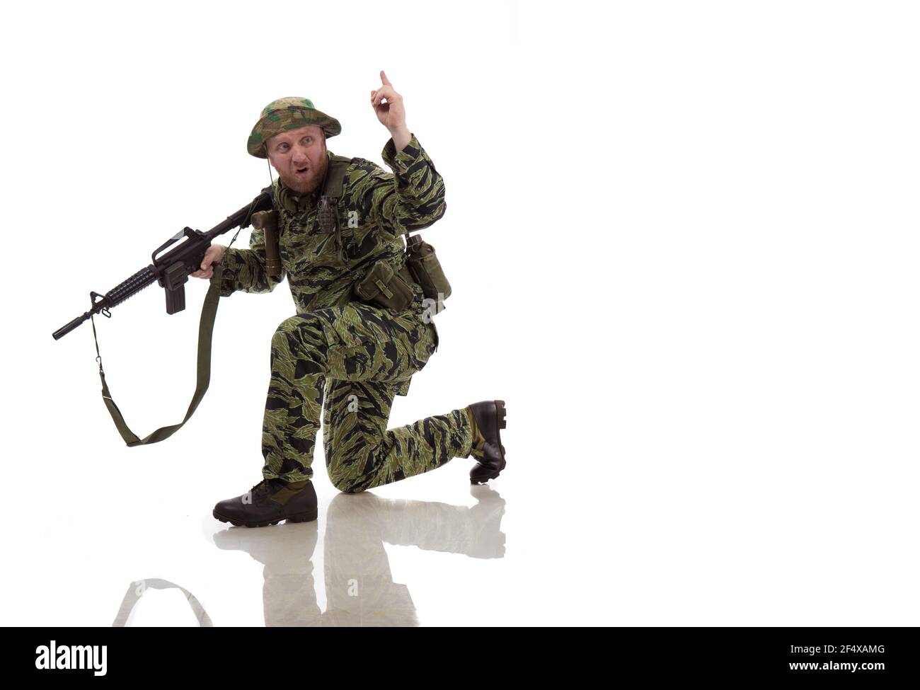 Man actor in the form of an American fur seal posing with a machine gun ...