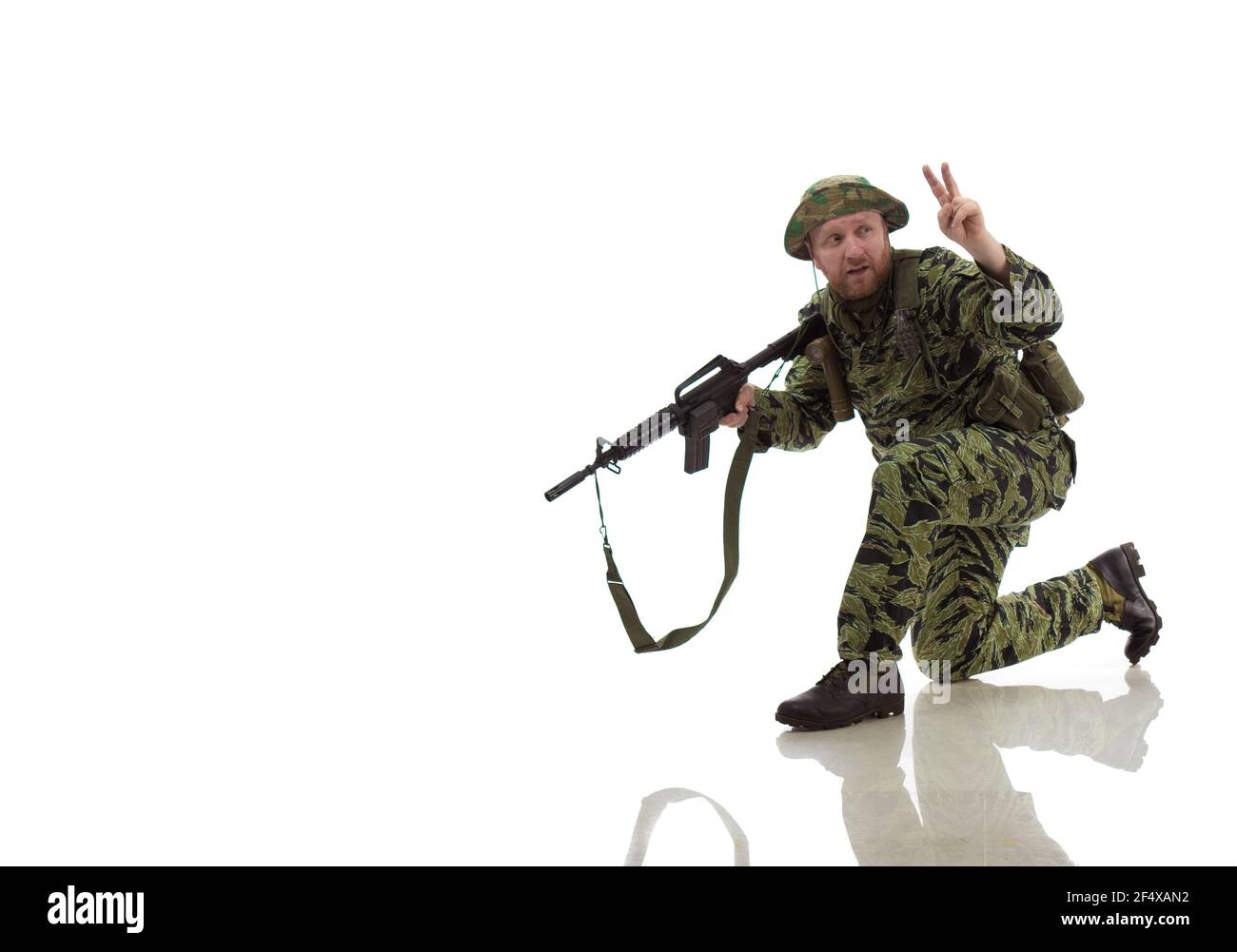 Man actor in the form of an American fur seal posing with a machine gun ...
