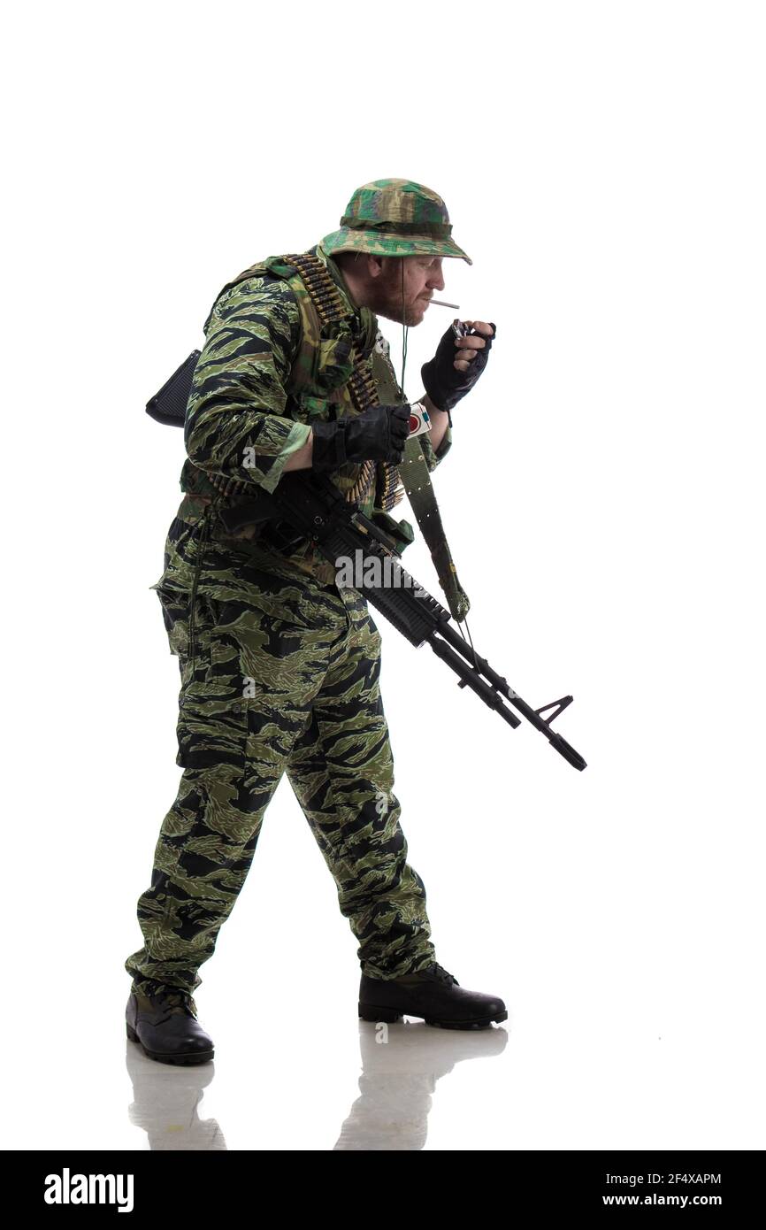 Man actor in the form of an American fur seal posing with a machine gun ...