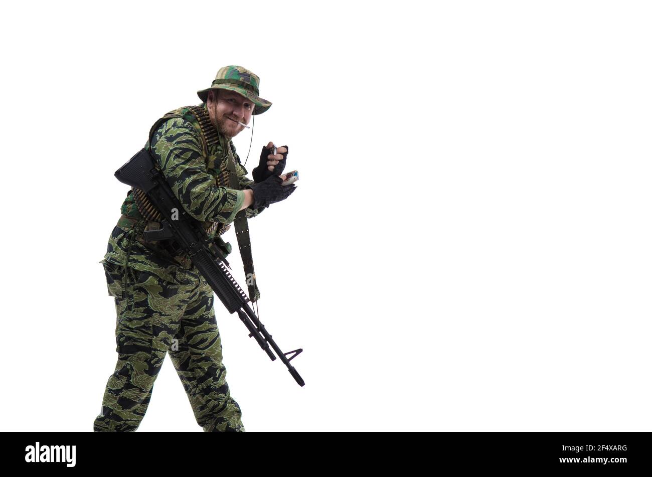 Man actor in the form of an American fur seal posing with a machine gun ...