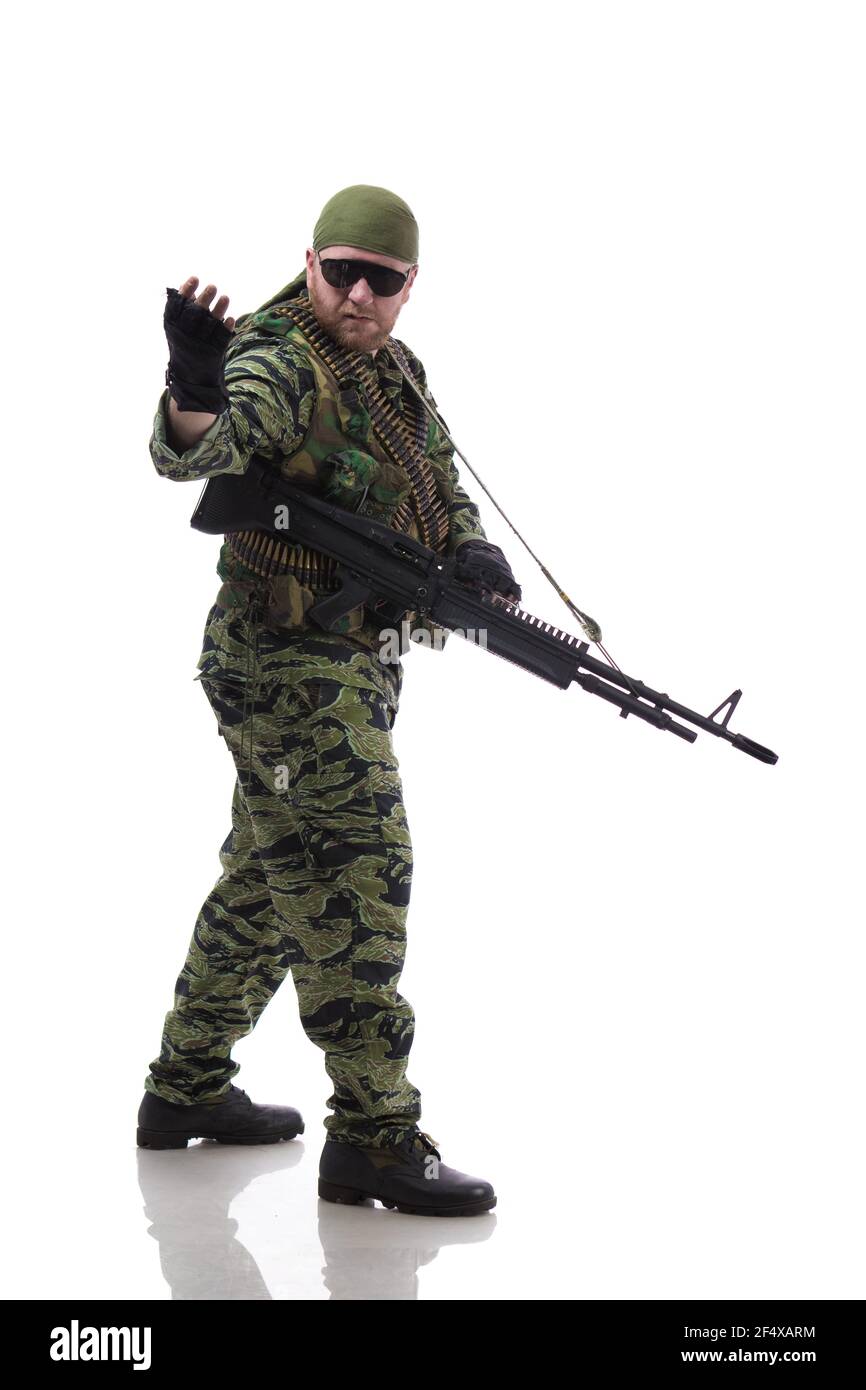 Man actor in the form of an American fur seal posing with a machine gun ...