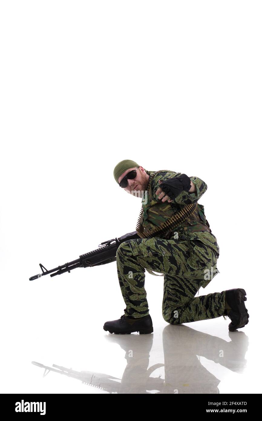 Man actor in the form of an American fur seal posing with a machine gun ...