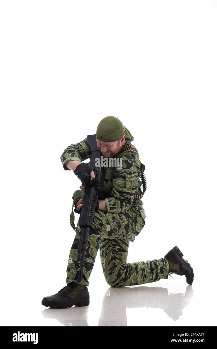 Man actor in the form of an American fur seal posing with a machine gun ...