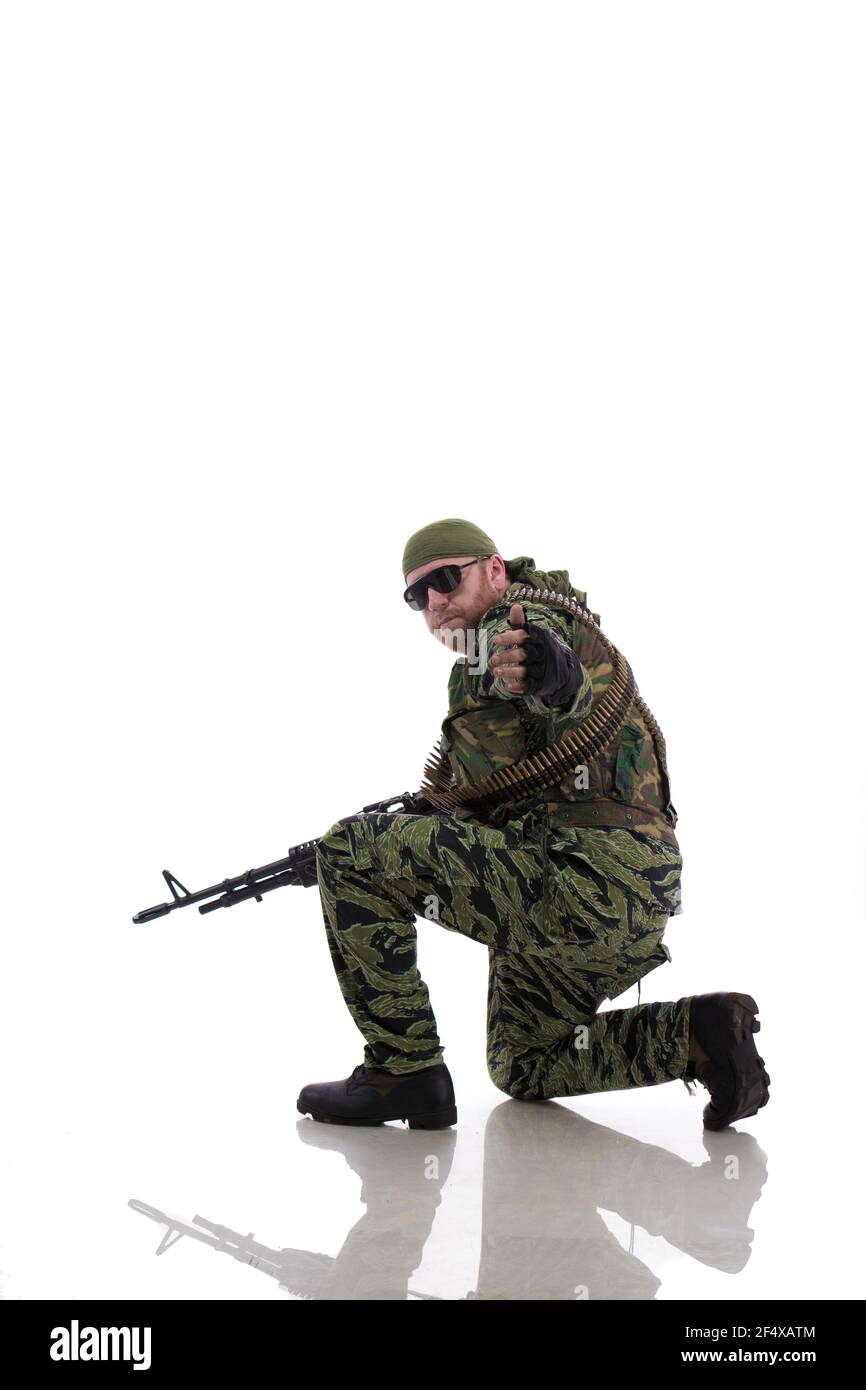 Man actor in the form of an American fur seal posing with a machine gun ...