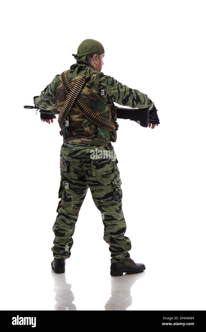 Man actor in the form of an American fur seal posing with a machine gun ...