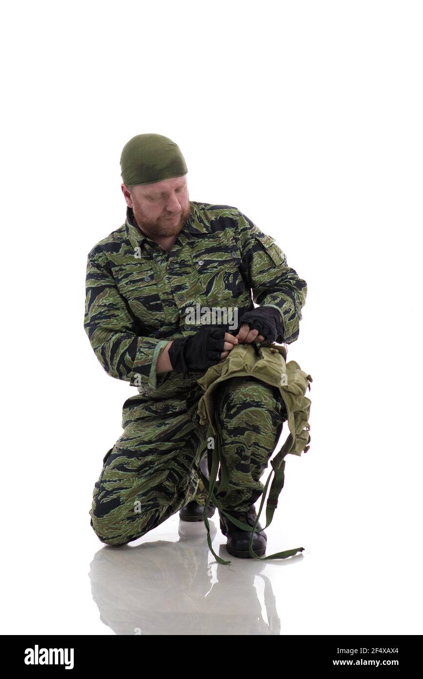 Man actor in the form of an American fur seal posing with a machine gun ...