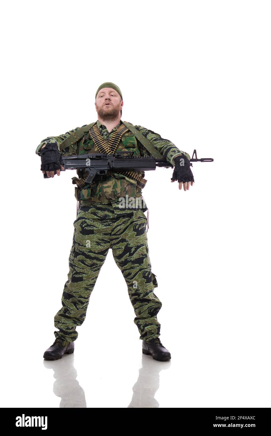 Man actor in the form of an American fur seal posing with a machine gun ...