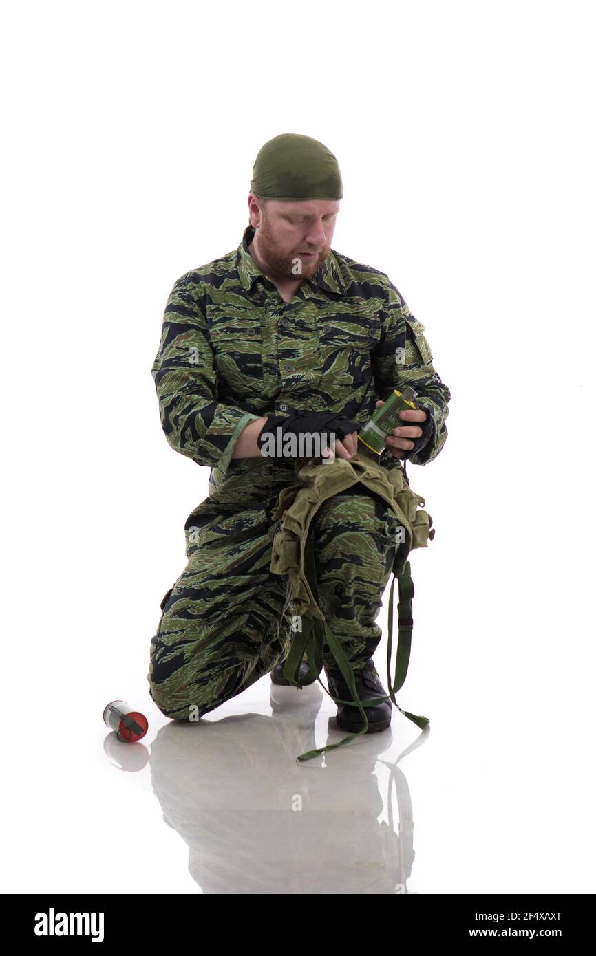 Man actor in the form of an American fur seal posing with a machine gun ...