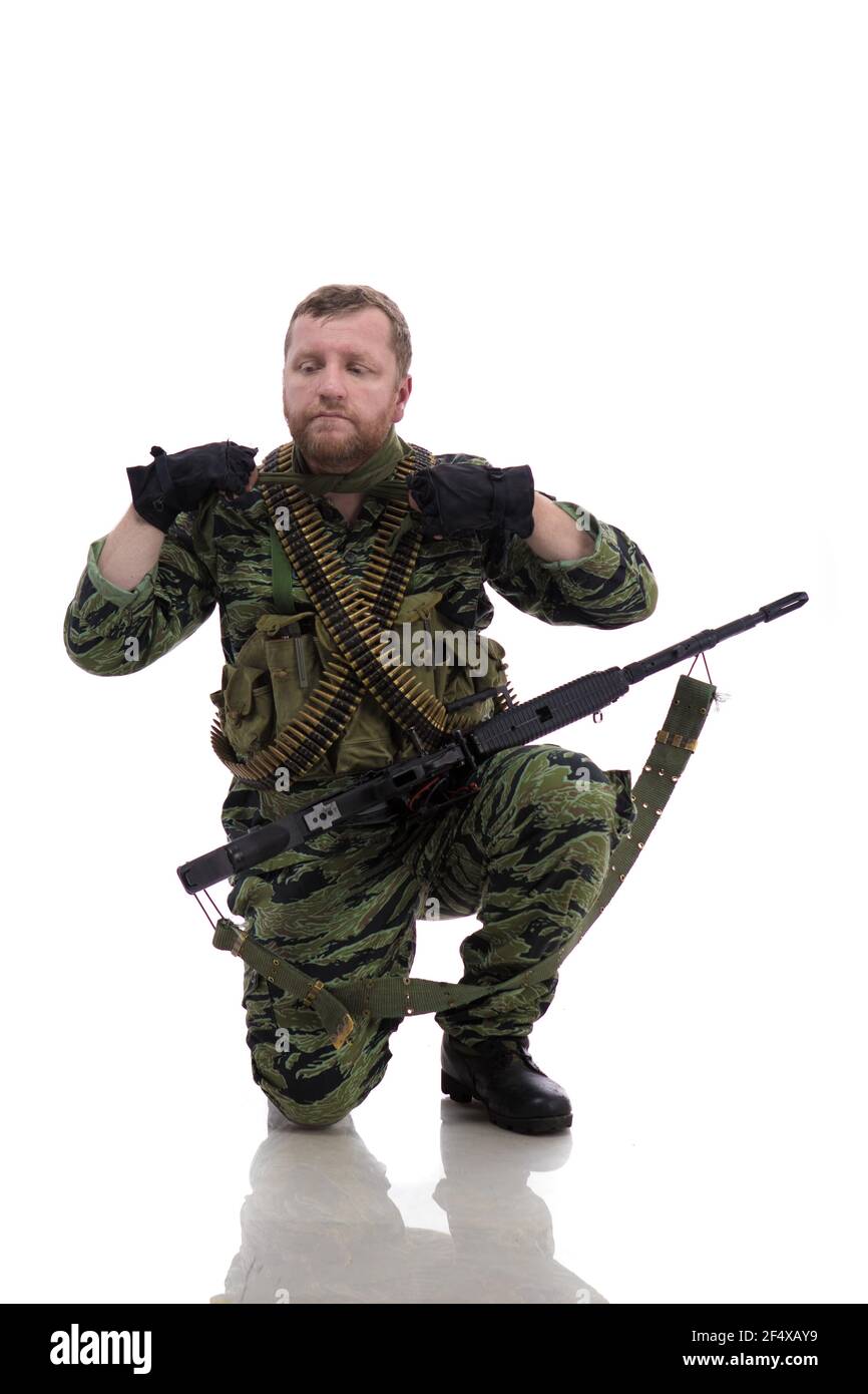 Man actor in the form of an American fur seal posing with a machine gun ...