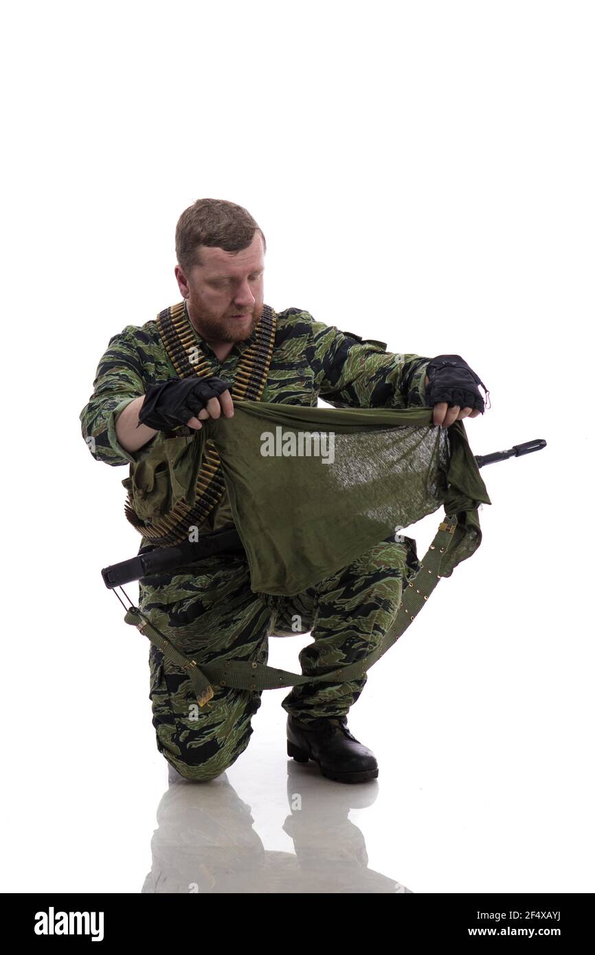 Man actor in the form of an American fur seal posing with a machine gun ...