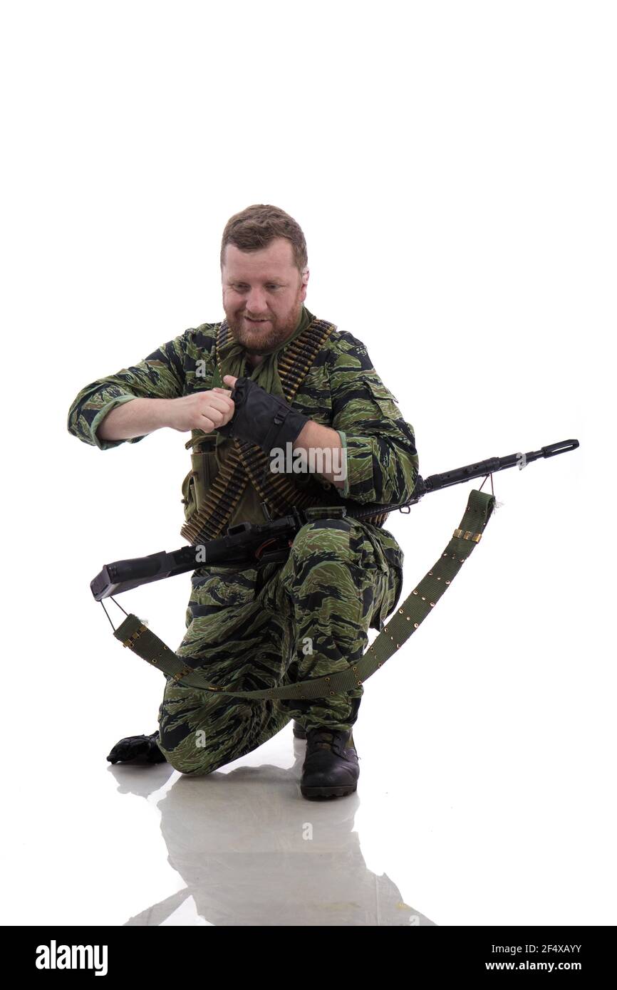 Man actor in the form of an American fur seal posing with a machine gun ...