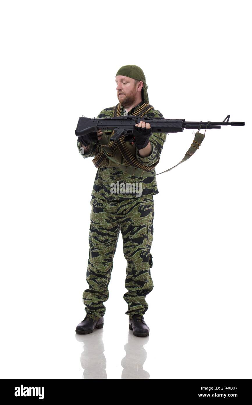 Man actor in the form of an American fur seal posing with a machine gun ...