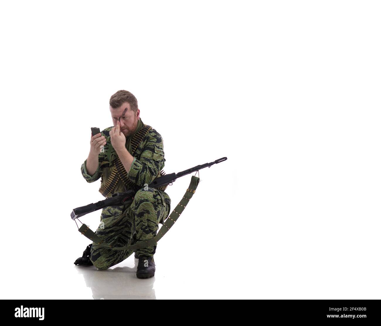 Man actor in the form of an American fur seal posing with a machine gun ...