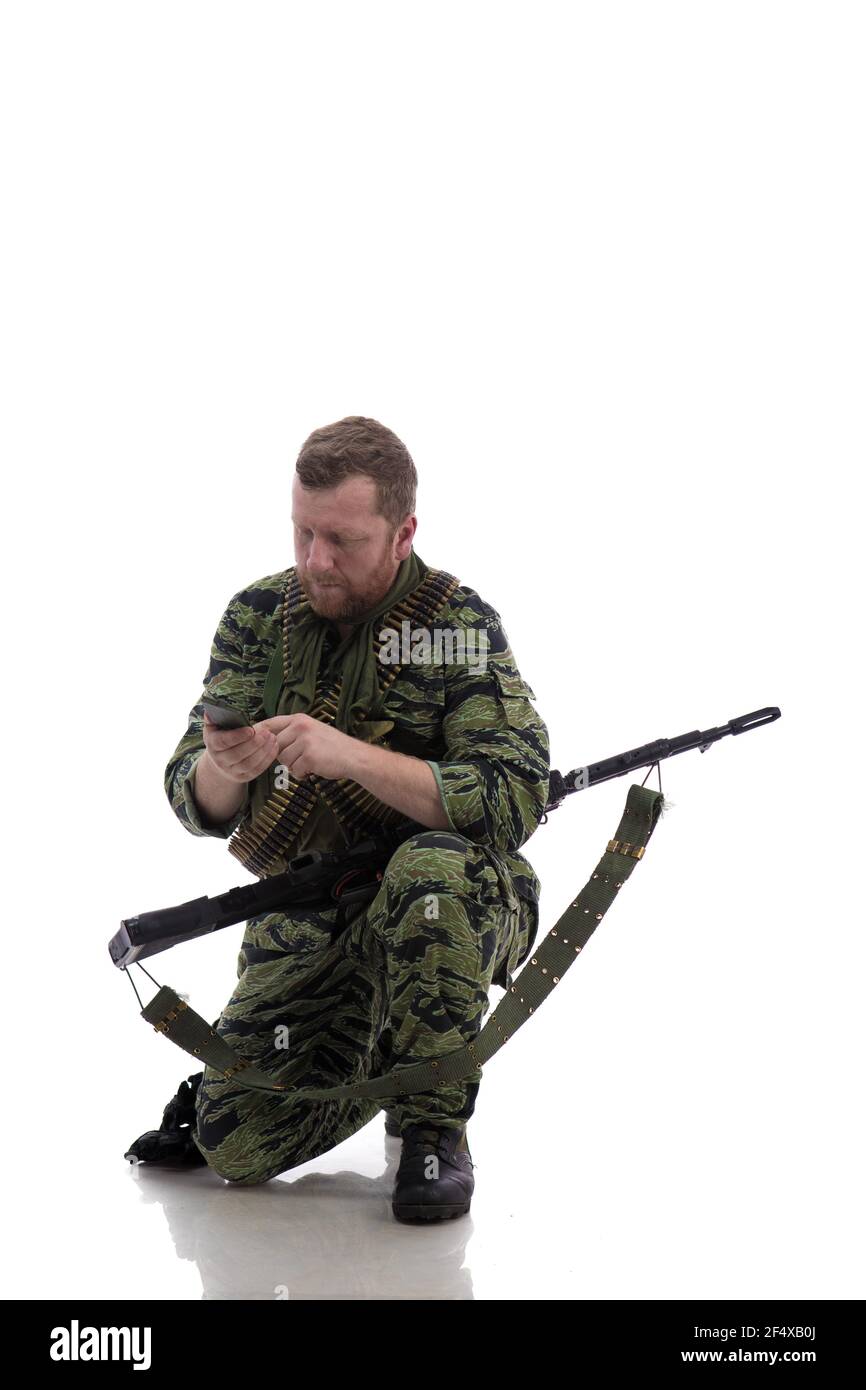 Man actor in the form of an American fur seal posing with a machine gun ...