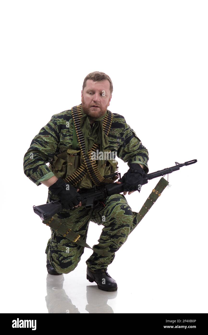Man actor in the form of an American fur seal posing with a machine gun ...