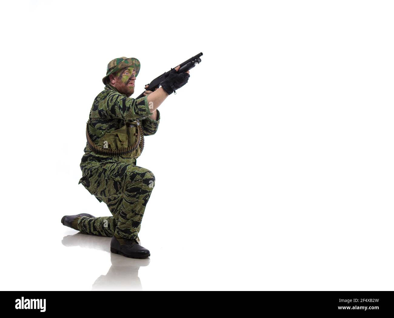 Man actor in the form of an American fur seal posing with a machine gun ...