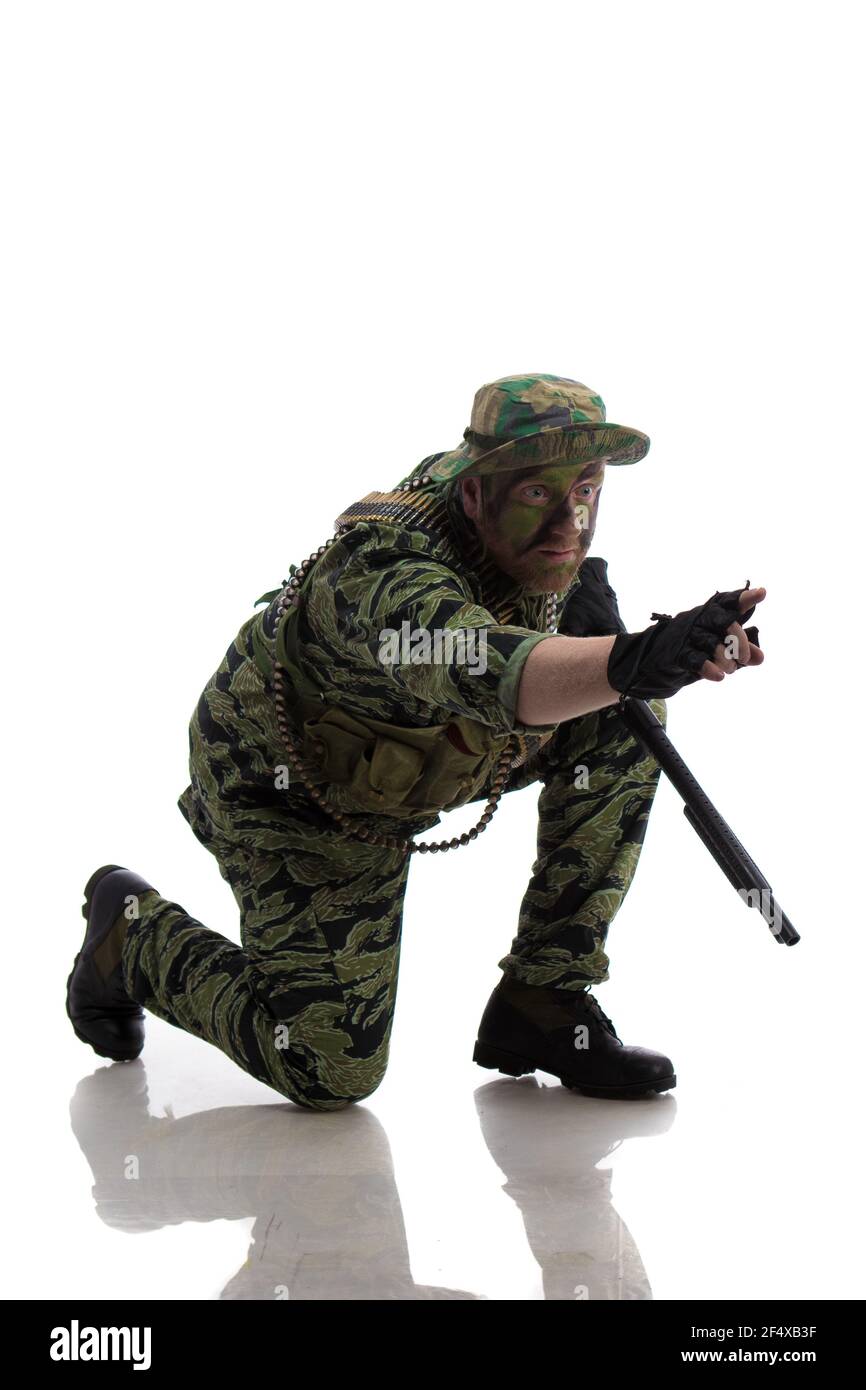 Man actor in the form of an American fur seal posing with a machine gun ...