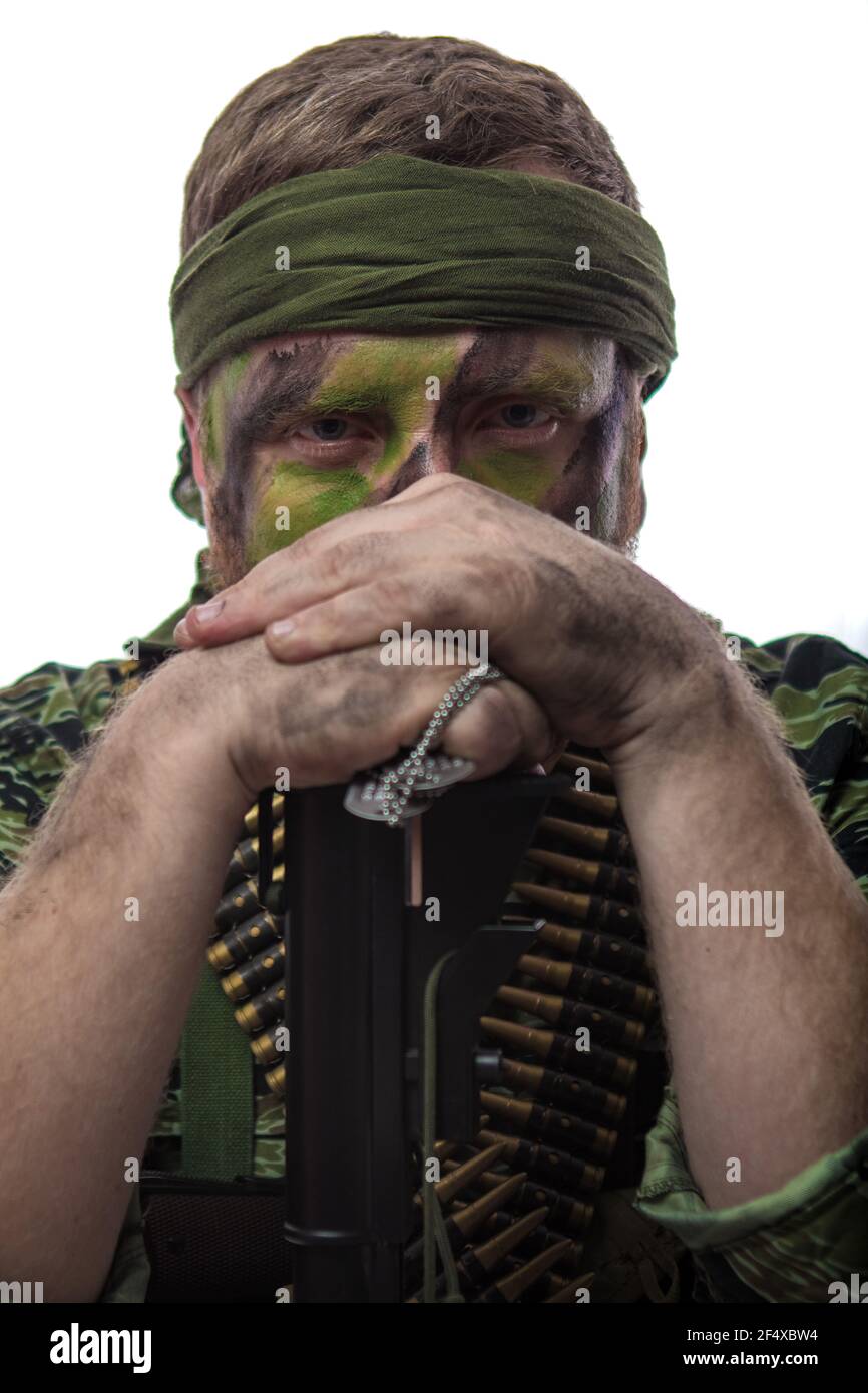 Man actor in the form of an American fur seal posing with a machine gun ...
