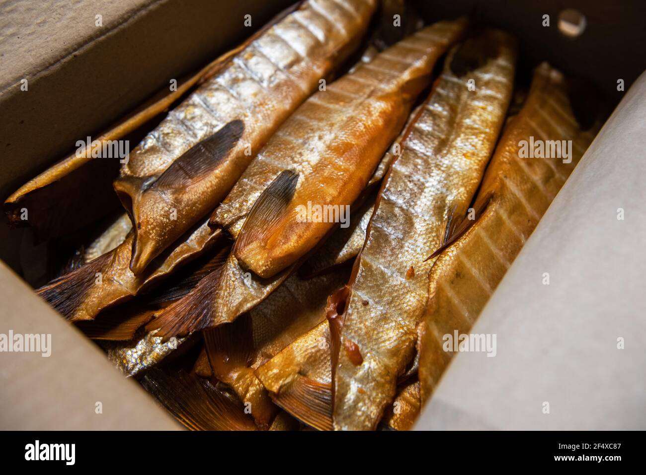 Smoked fish in craft paper box. Ready for delivery production. Smoked ...