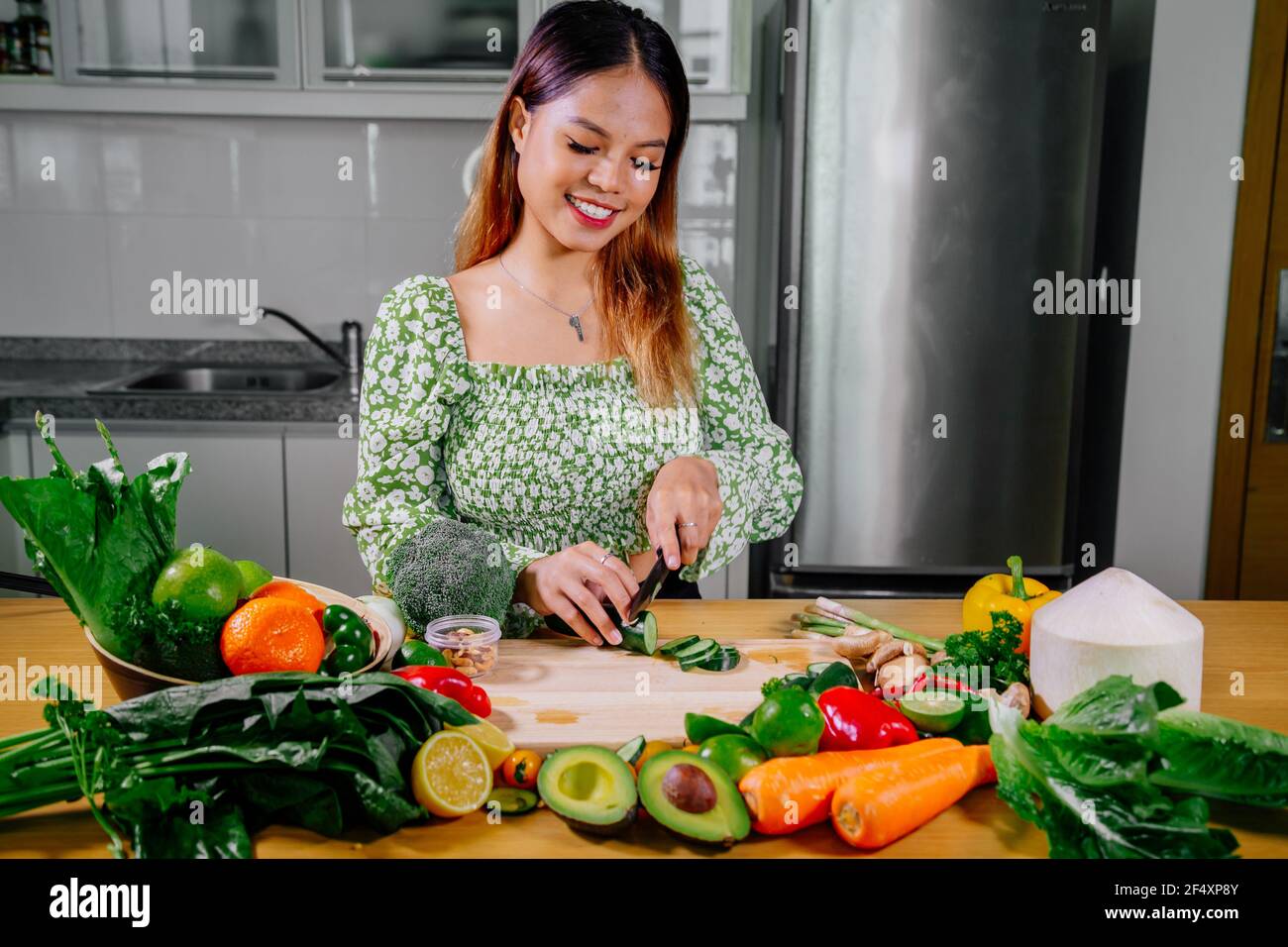 Asian girl cooking healthy vegetarian and vegan food, vegetables and ...
