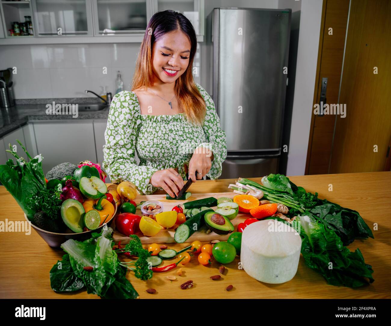 Asian girl cooking healthy vegetarian and vegan food, vegetables and ...