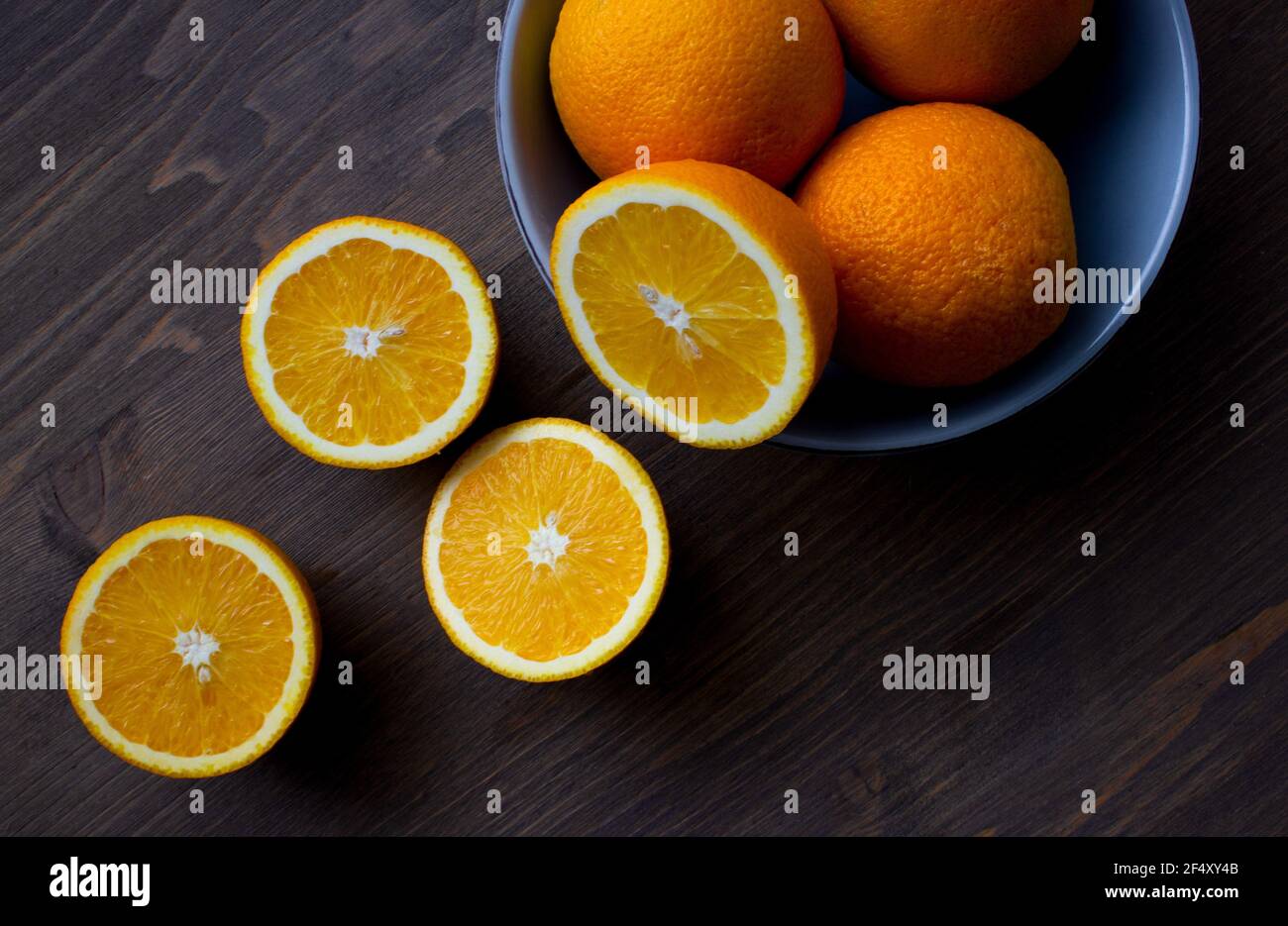 Fresh oranges in a light blue bowl on a dark wood background Stock ...