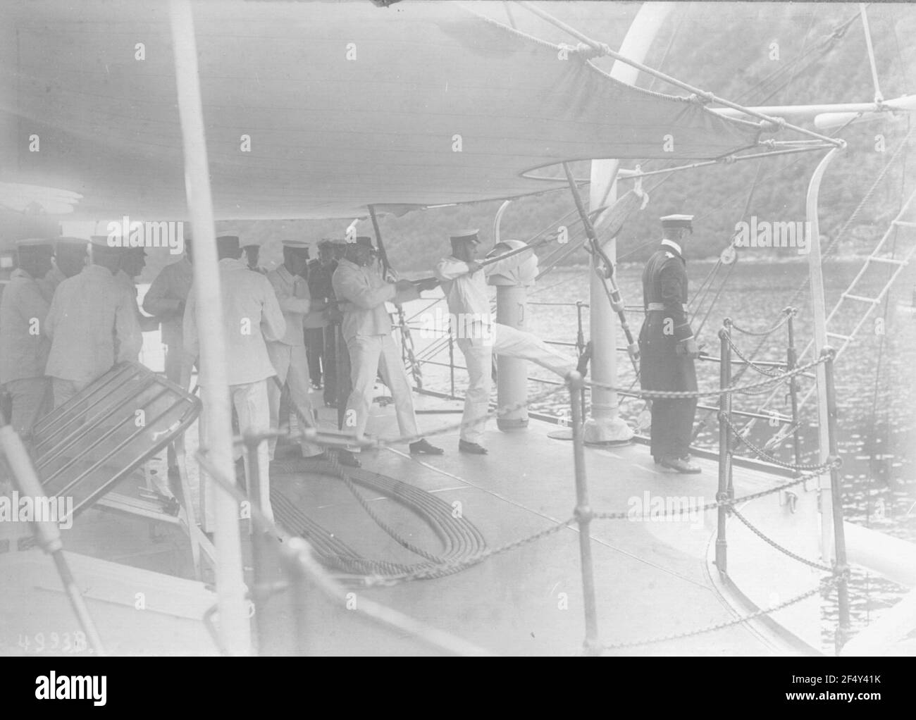 Kaiser Wilhelm II on the railing, behind him pull several sailors on a ...