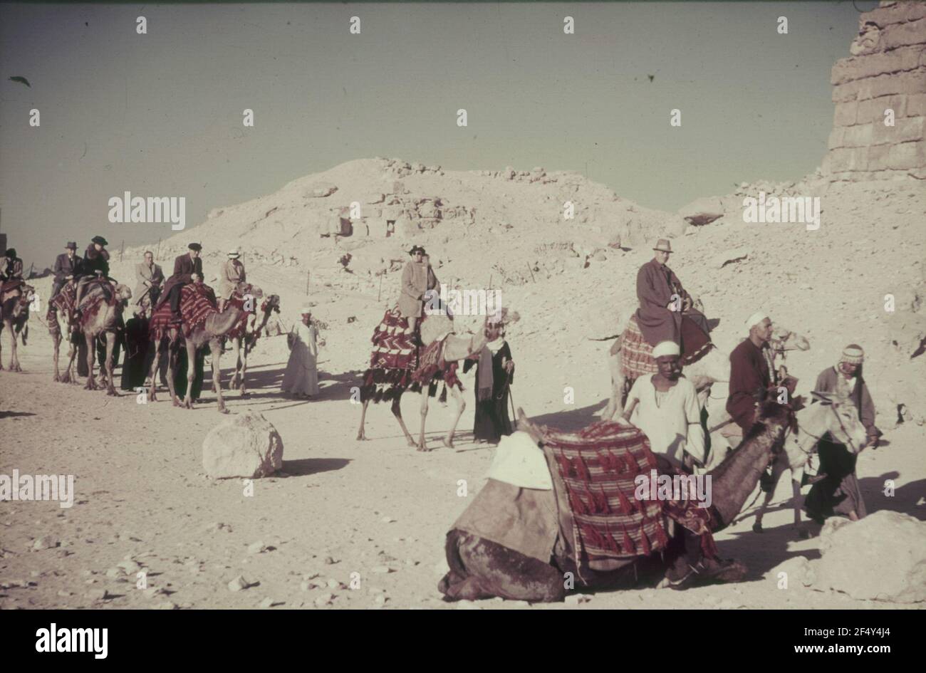 Travel photos Egypt. Camel leader and tourists in the desert Stock ...