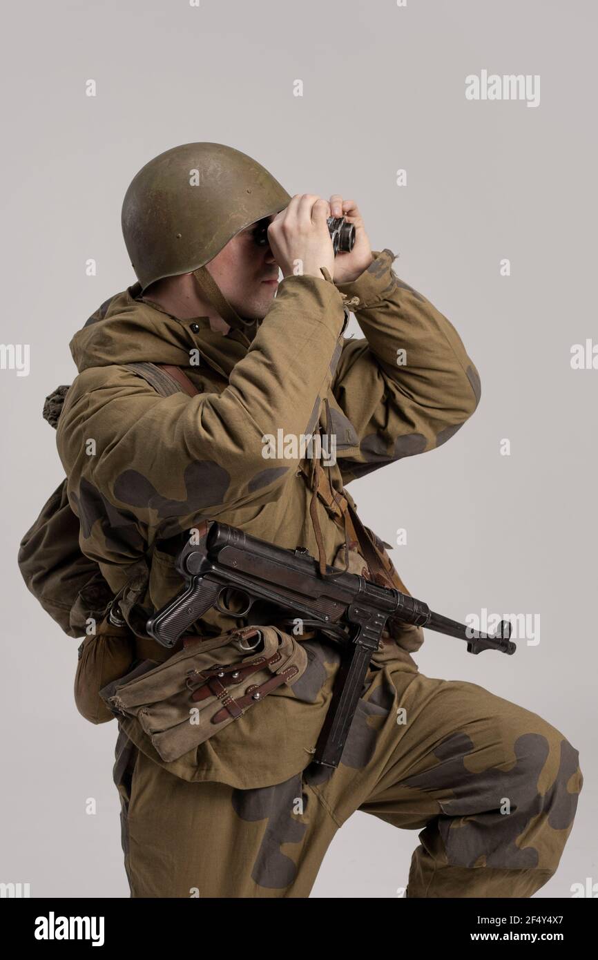 Adult man in an old military uniform and camouflage clothing of a ...