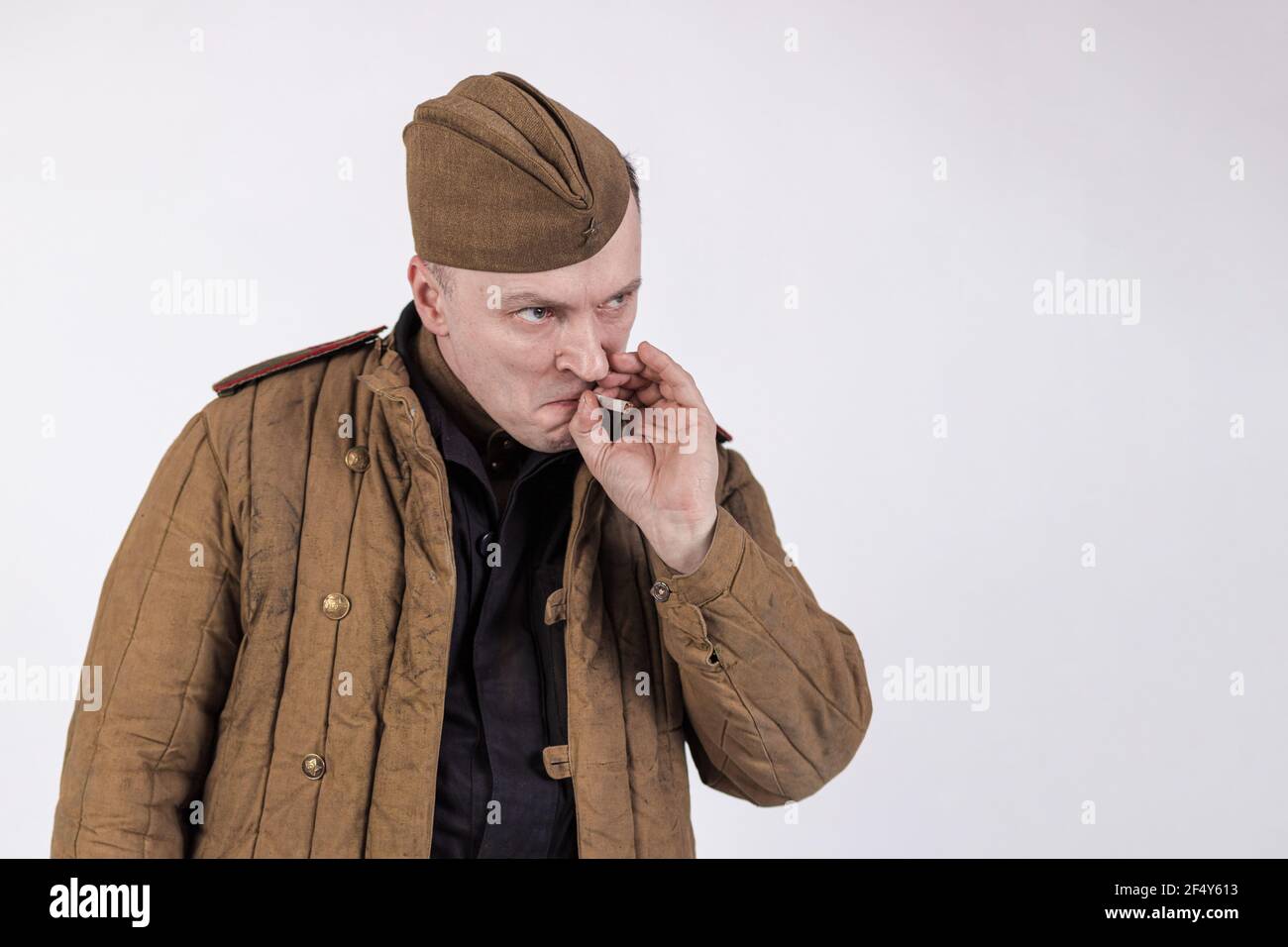 Portrait of a male actor in military uniform of an Russian tankman of ...
