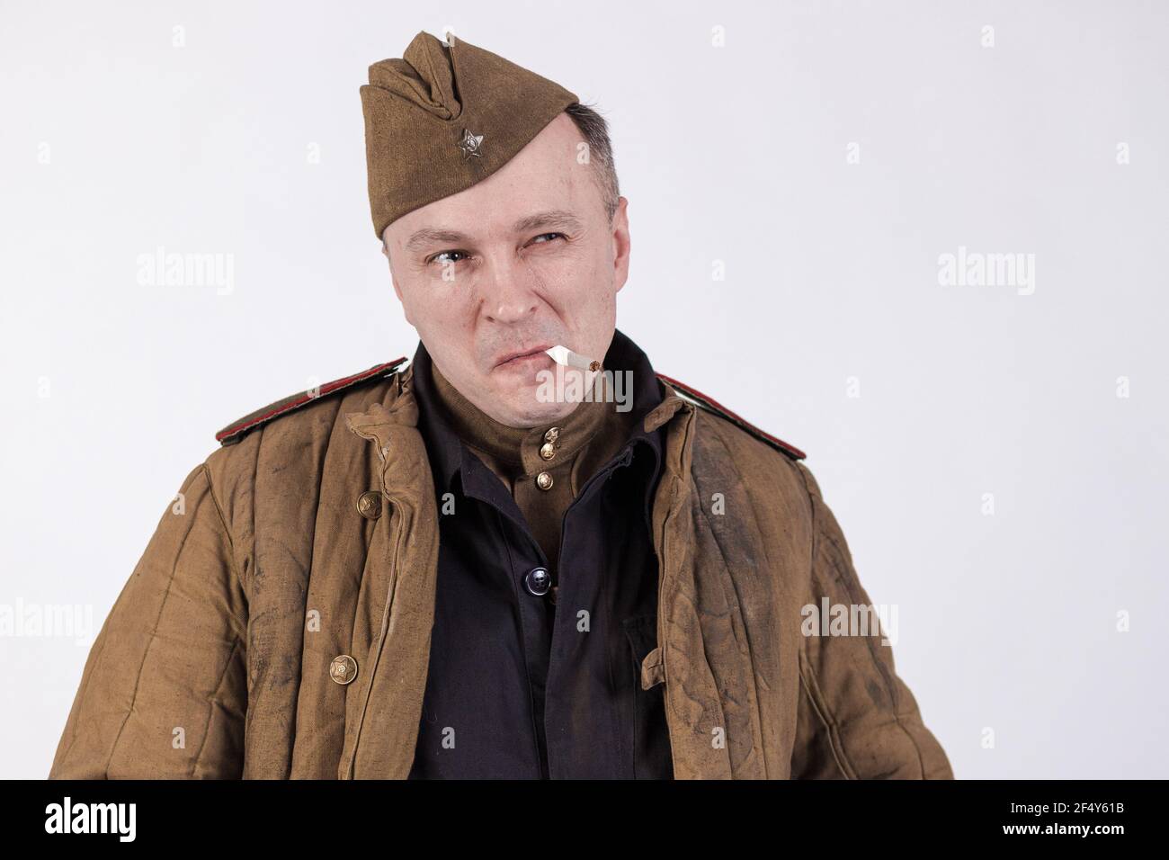 Portrait of a male actor in military uniform of an Russian tankman of ...