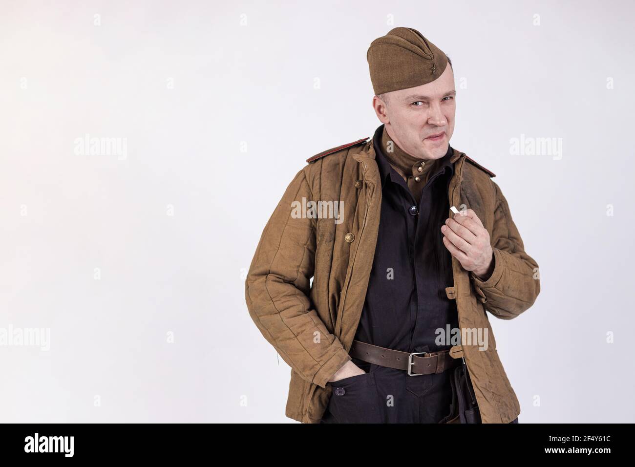 Portrait of a male actor in military uniform of an Russian tankman of ...