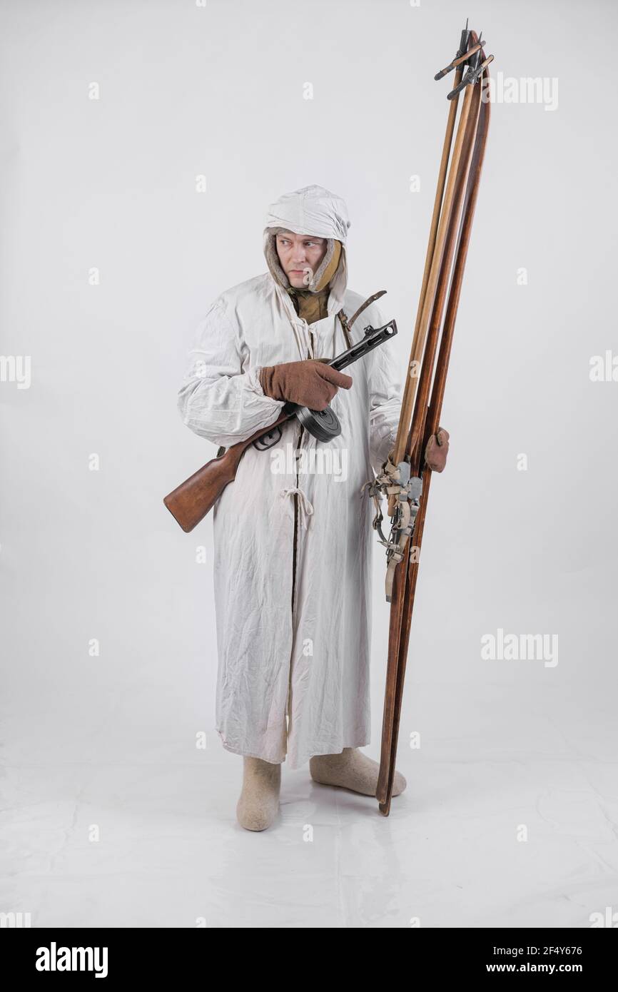 A man in a winter military uniform white camouflage, a soldier of the ...