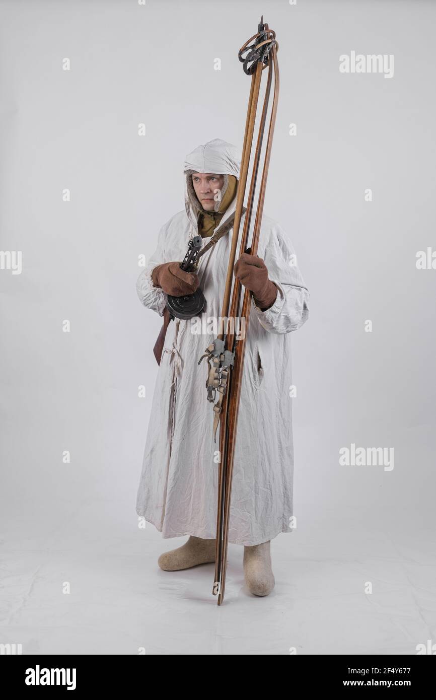 A man in a winter military uniform white camouflage, a soldier of the ...