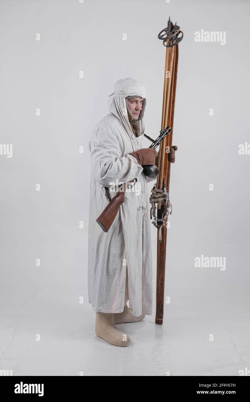 A man in a winter military uniform white camouflage, a soldier of the ...
