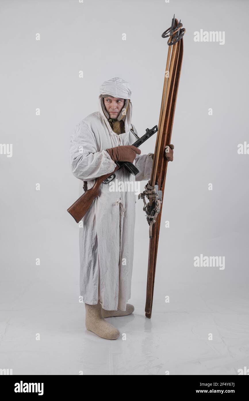 A man in a winter military uniform white camouflage, a soldier of the ...