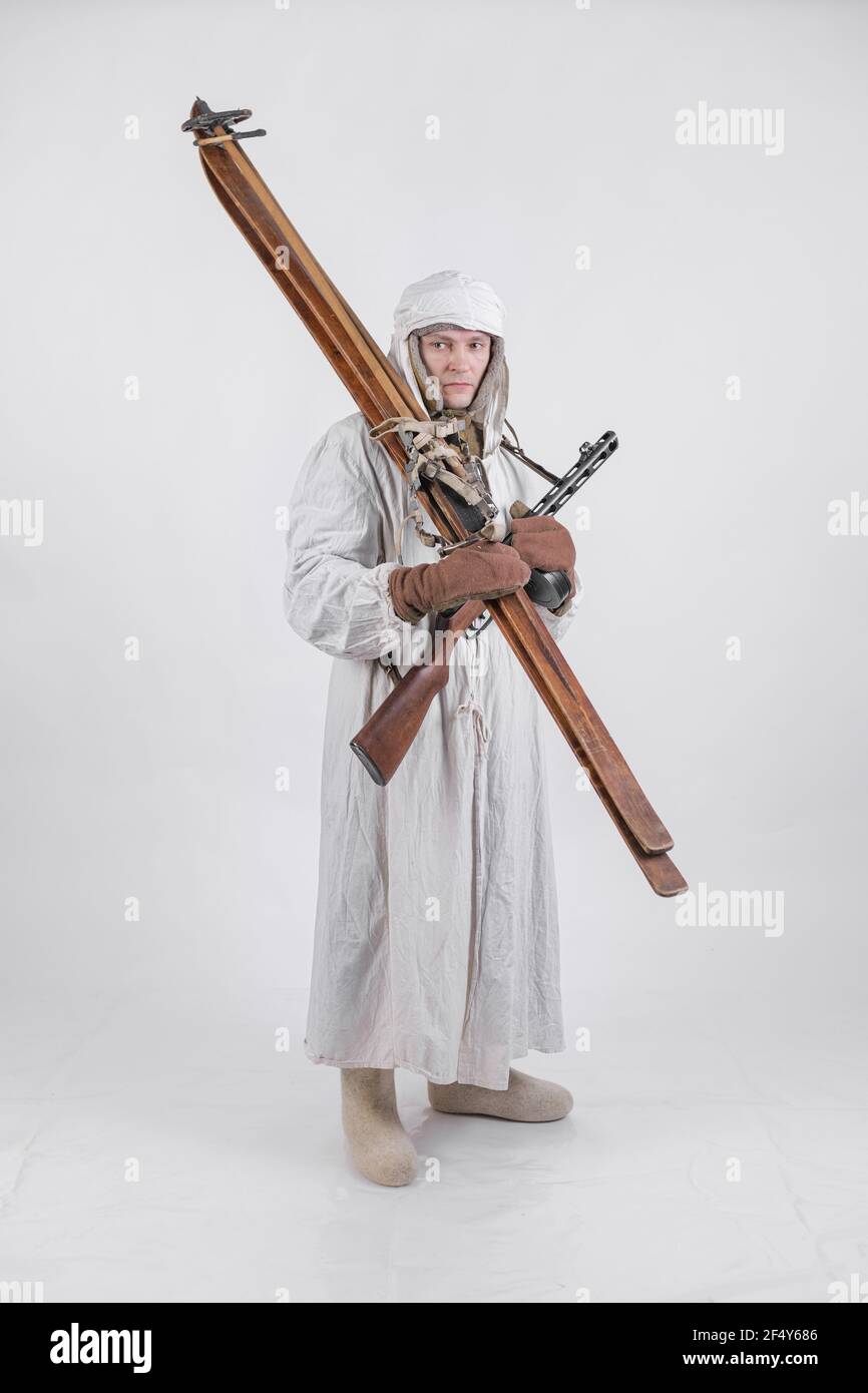 A man in a winter military uniform white camouflage, a soldier of the ...