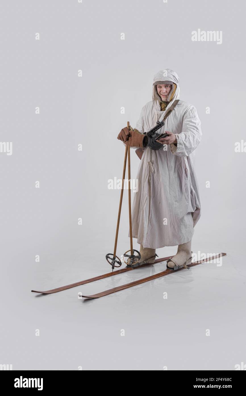 A man in a winter military uniform white camouflage, a soldier of the ...