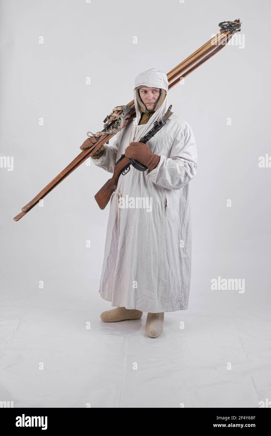 A man in a winter military uniform white camouflage, a soldier of the ...