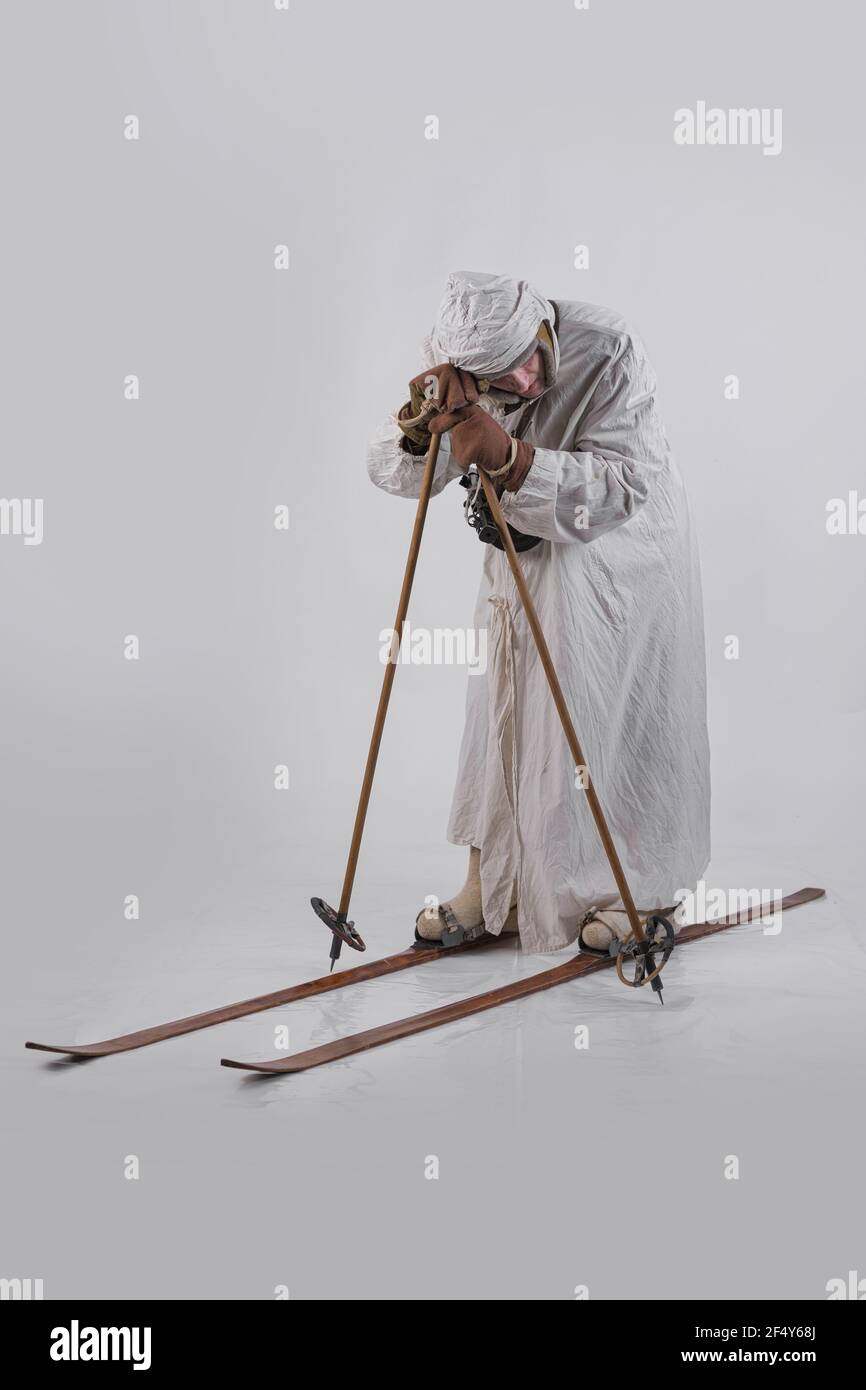 A man in a winter military uniform white camouflage, a soldier of the ...