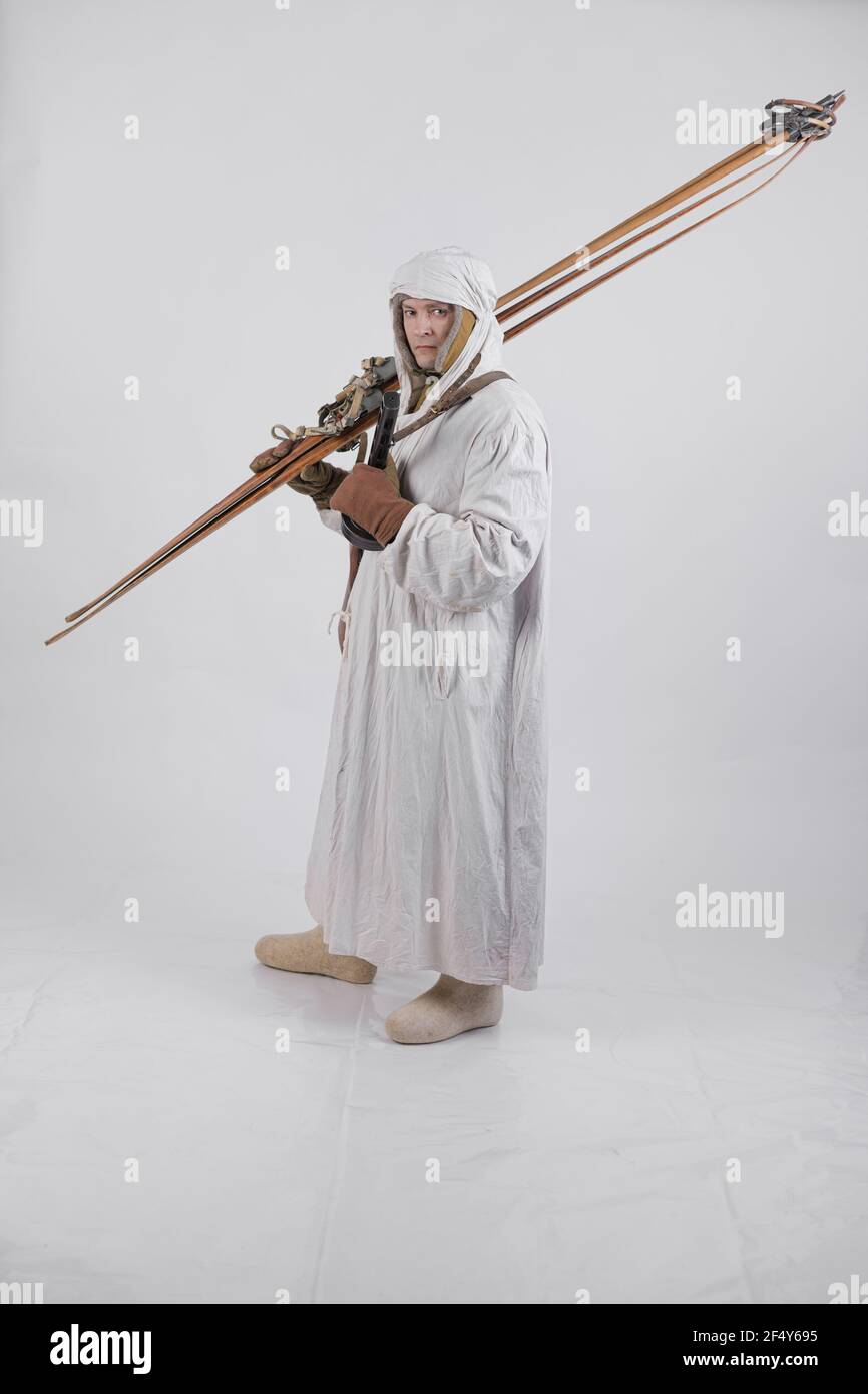 A man in a winter military uniform white camouflage, a soldier of the ...