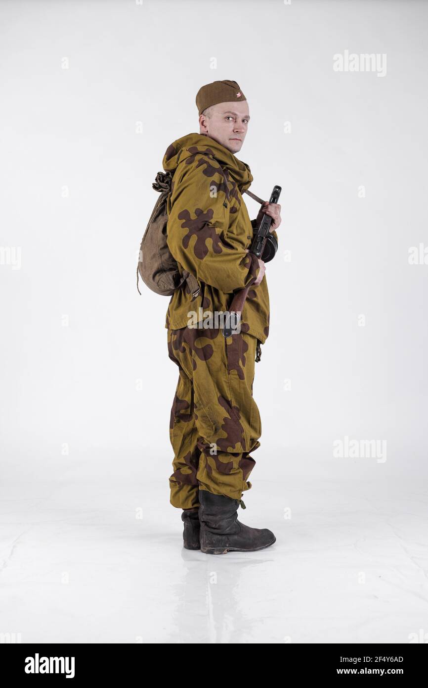 Actor man in an old military uniform and camouflage sniper marksman ...