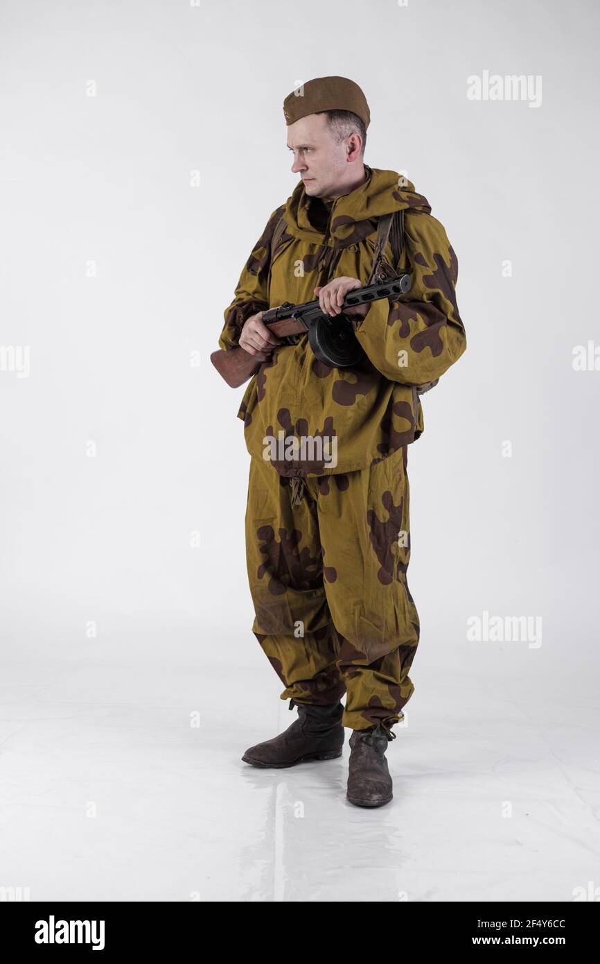 Actor man in an old military uniform and camouflage sniper marksman ...