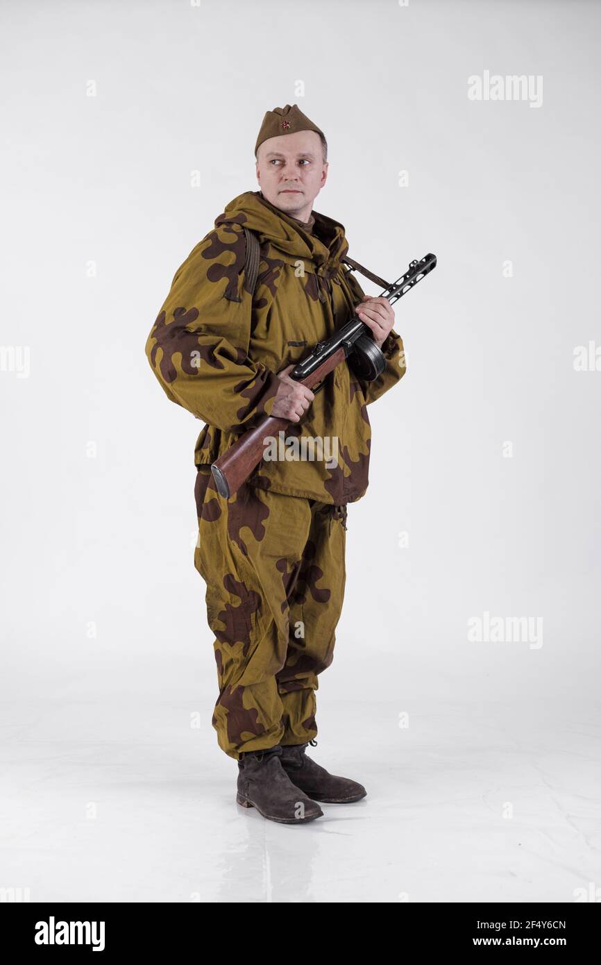 Actor man in an old military uniform and camouflage sniper marksman ...